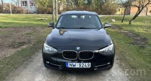 Black BMW 118 2012 in Bauska, with an engine capacity of 2.00 L and mileage of 253 thousand km for 8400 €, photo 1 on AUTOMOTO.COM.LV