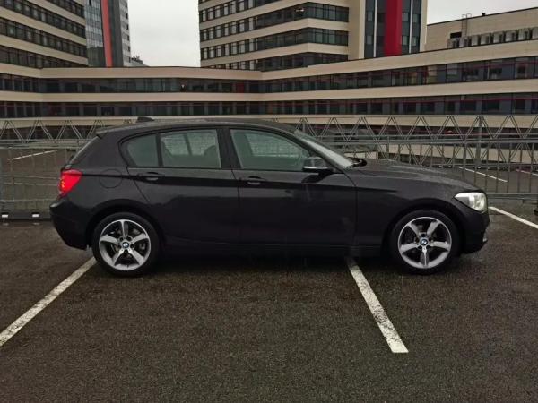 Black BMW 118 2012 in Riga, with an engine capacity of 2.00 L and mileage of 235 thousand km for 9990 €, photo 4 on AUTOMOTO.COM.LV