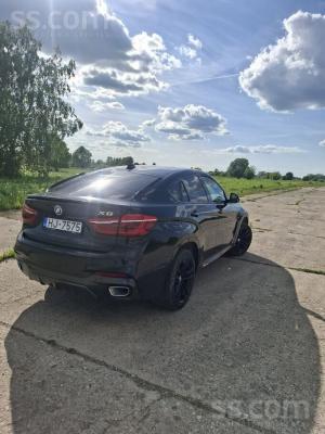 Black BMW X6 2019 in Riga, with an engine capacity of 3.00 L and mileage of 149 thousand km for 32750 €, photo 4 on AUTOMOTO.COM.LV