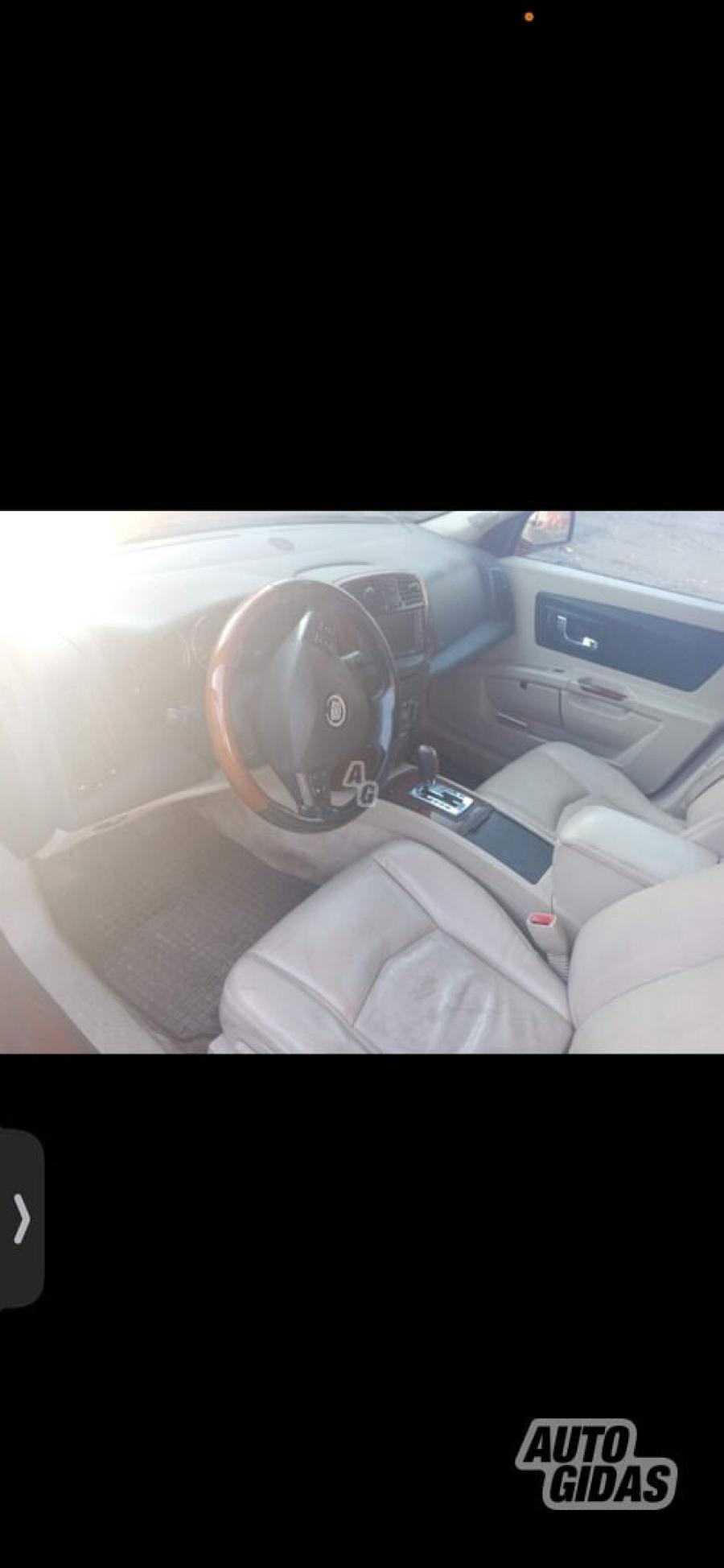 Red Cadillac SRX 2005 in Kaunas, with an engine capacity of 3.60 L and mileage of 180 thousand km for 1200 €, photo 8 on AUTOMOTO.COM.LV