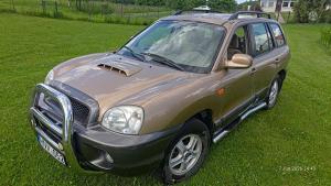 Yellow Hyundai Santa Fe 2002 in Vilnius, with an engine capacity of 1.99 L and mileage of 312 thousand km for 1500 €, photo  on AUTOMOTO.COM.LV