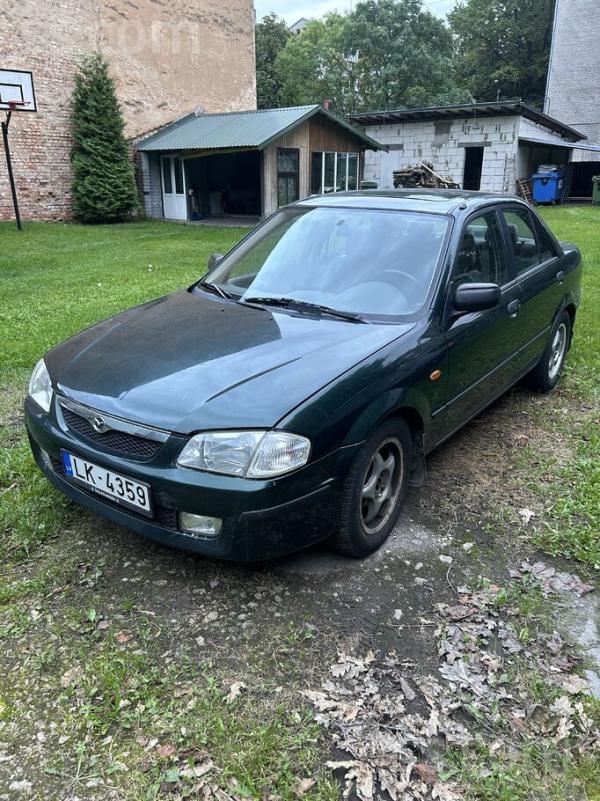 Mazda 323 1999 Rīga vietnē Zaļš Mazda 323 1999 Rīga, ar dzinēja tilpumu 1.50 L un nobraukumu 252 tūkst. km par 1000 €, foto 1 vietnē AUTOMOTO.COM.LV
