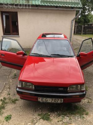 Sarkans Mazda 323 1989 Cēsis, ar dzinēja tilpumu 1.60 L un nobraukumu 211 tūkst. km par 3500 €, foto  vietnē AUTOMOTO.COM.LV