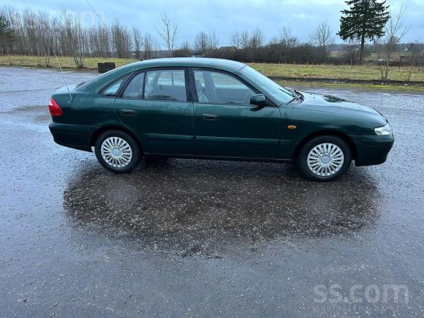 Green Mazda 626 1999 in Ventspils, with an engine capacity of 1.80 L and mileage of 230 thousand km for 1000 €, photo 4 on AUTOMOTO.COM.LV