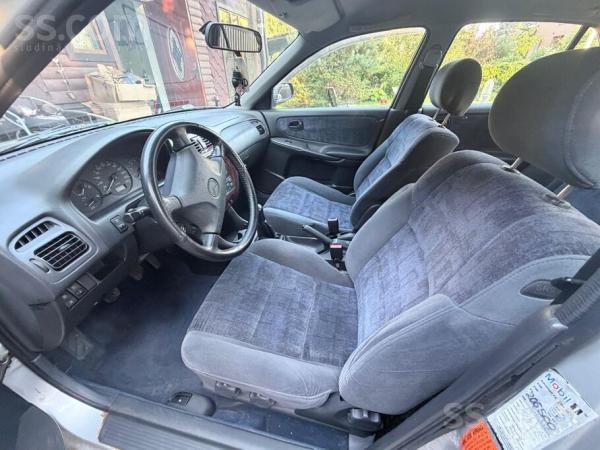 Grey Mazda 626 1998 in Riga, with an engine capacity of 2.00 L and mileage of 228 thousand km for 1199 €, photo 9 on AUTOMOTO.COM.LV