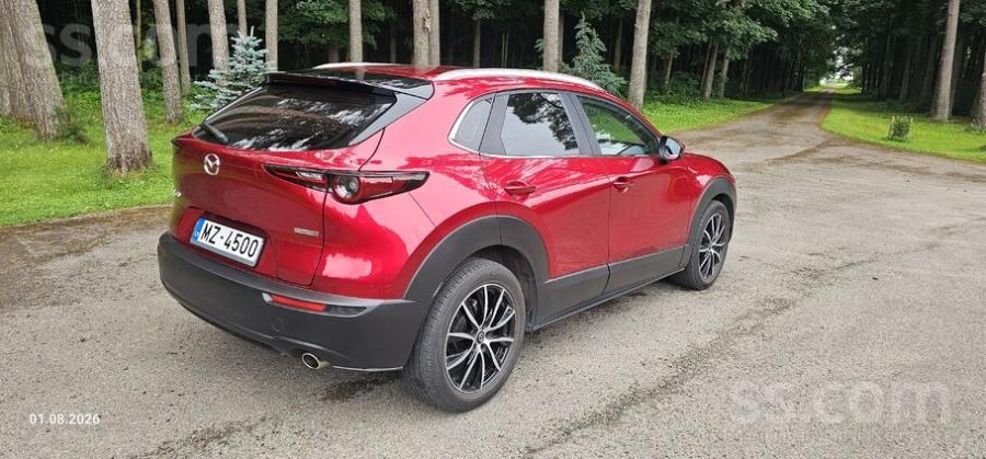 Red Mazda CX-30 2021 in Riga, with an engine capacity of 2.00 L and mileage of 35 thousand km for 18700 €, photo 4 on AUTOMOTO.COM.LV