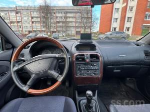 Green Mitsubishi Carisma 1999 in Riga, with an engine capacity of 1.80 L and mileage of 260 thousand km for 1450 €, photo 8 on AUTOMOTO.COM.LV