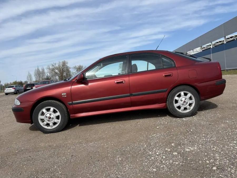 Red Mitsubishi Carisma 2000 in Daugavpils, with an engine capacity of 1.80 L and mileage of 245 thousand km for 1450 €, photo 3 on AUTOMOTO.COM.LV