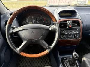 Red Mitsubishi Carisma 2000 in Daugavpils, with an engine capacity of 1.80 L and mileage of 245 thousand km for 1450 €, photo 11 on AUTOMOTO.COM.LV