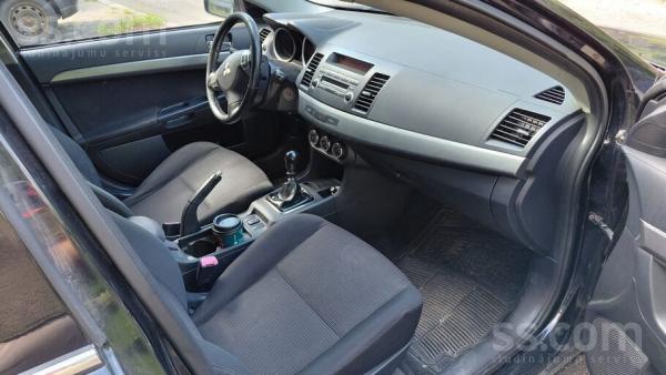 Black Mitsubishi Lancer 2011 in Riga, with an engine capacity of 1.80 L and mileage of 380 thousand km for 3800 €, photo 8 on AUTOMOTO.COM.LV