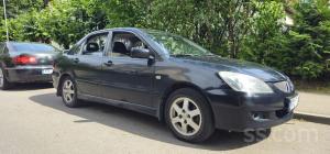 Black Mitsubishi Lancer 2005 in Riga, with an engine capacity of 1.40 L and mileage of 130 thousand km for 1200 €, photo 3 on AUTOMOTO.COM.LV