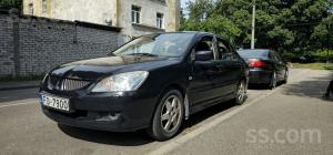 Black Mitsubishi Lancer 2005 in Riga, with an engine capacity of 1.40 L and mileage of 130 thousand km for 1200 €, photo 4 on AUTOMOTO.COM.LV