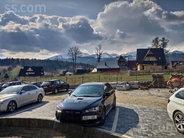 Black Mitsubishi lancer-evolution 2011 in Riga, with an engine capacity of 2.00 L and mileage of 163 thousand km for 13500 €, photo 3 on AUTOMOTO.COM.LV