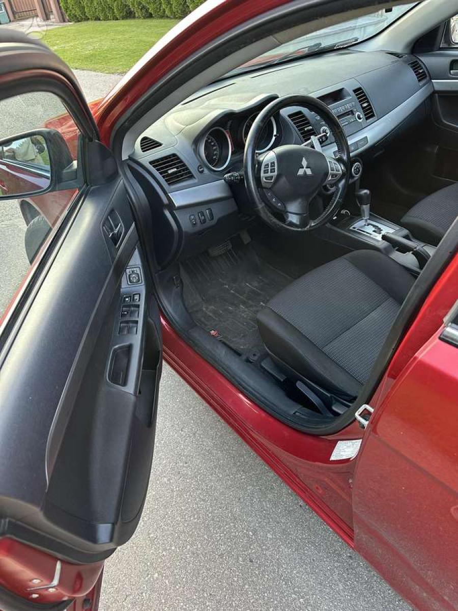 Red Mitsubishi Lancer 2009 in Vilnius, with an engine capacity of 1.80 L and mileage of 249 thousand km for 1950 €, photo 10 on AUTOMOTO.COM.LV