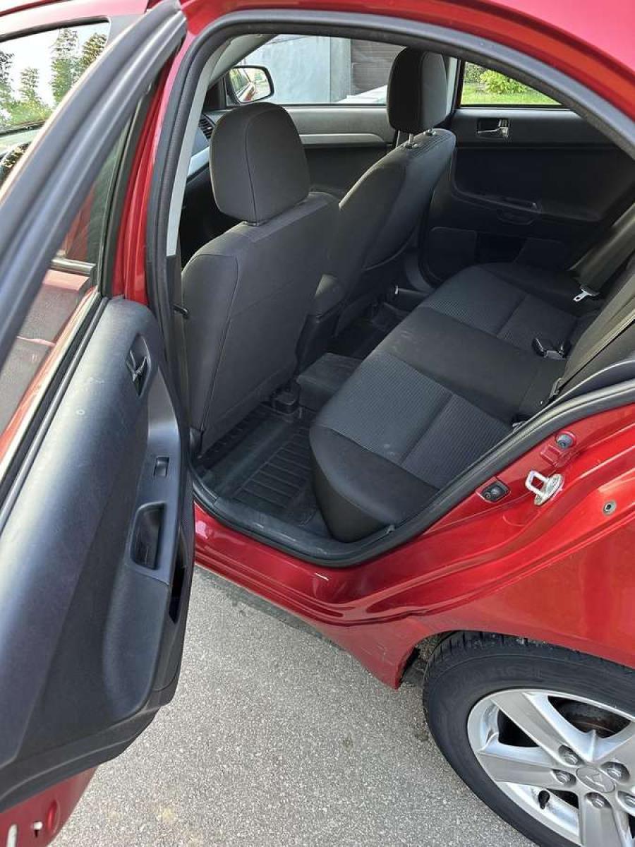 Red Mitsubishi Lancer 2009 in Vilnius, with an engine capacity of 1.80 L and mileage of 249 thousand km for 1950 €, photo 13 on AUTOMOTO.COM.LV