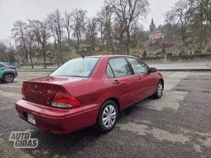 Red Mitsubishi Lancer 2002 in Marijampole, with an engine capacity of 2.00 L and mileage of 194 thousand km for 1800 €, photo 8 on AUTOMOTO.COM.LV