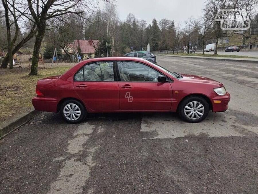 Red Mitsubishi Lancer 2002 in Marijampole, with an engine capacity of 2.00 L and mileage of 194 thousand km for 1800 €, photo 11 on AUTOMOTO.COM.LV