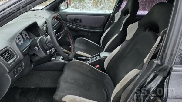 Black Subaru Impreza 1998 in Riga, with an engine capacity of 2.00 L and mileage of 295 thousand km for 7500 €, photo 8 on AUTOMOTO.COM.LV
