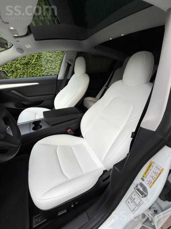White Tesla Model 3 2023 in Riga, with an engine capacity of 0.00 L and mileage of 65 thousand km for 31000 €, photo 8 on AUTOMOTO.COM.LV