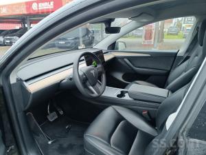 Black Tesla Model Y 2022 in Riga, with an engine capacity of 0.00 L and mileage of 74 thousand km for 31700 €, photo 8 on AUTOMOTO.COM.LV