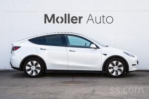 White Tesla Model Y 2023 in Riga, with an engine capacity of 0.00 L and mileage of 62 thousand km for 39500 €, photo 6 on AUTOMOTO.COM.LV