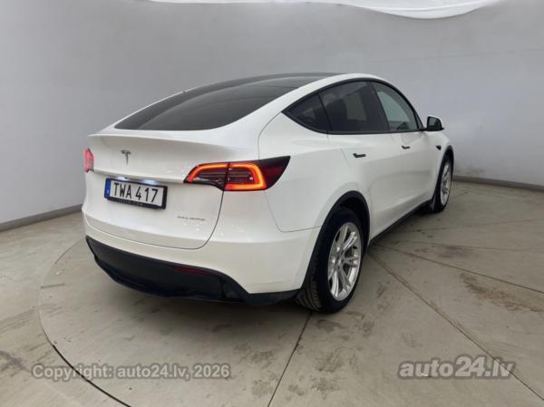 White Tesla Model Y 2023 in Tallinn, with an engine capacity of 0.00 L and mileage of 49 thousand km for 38990 €, photo 4 on AUTOMOTO.COM.LV
