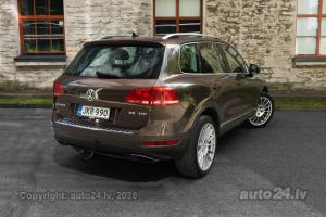 Brown Volkswagen Touareg 2011 in Tallinn, with an engine capacity of 4.20 L and mileage of 242 thousand km for 10999 €, photo 5 on AUTOMOTO.COM.LV
